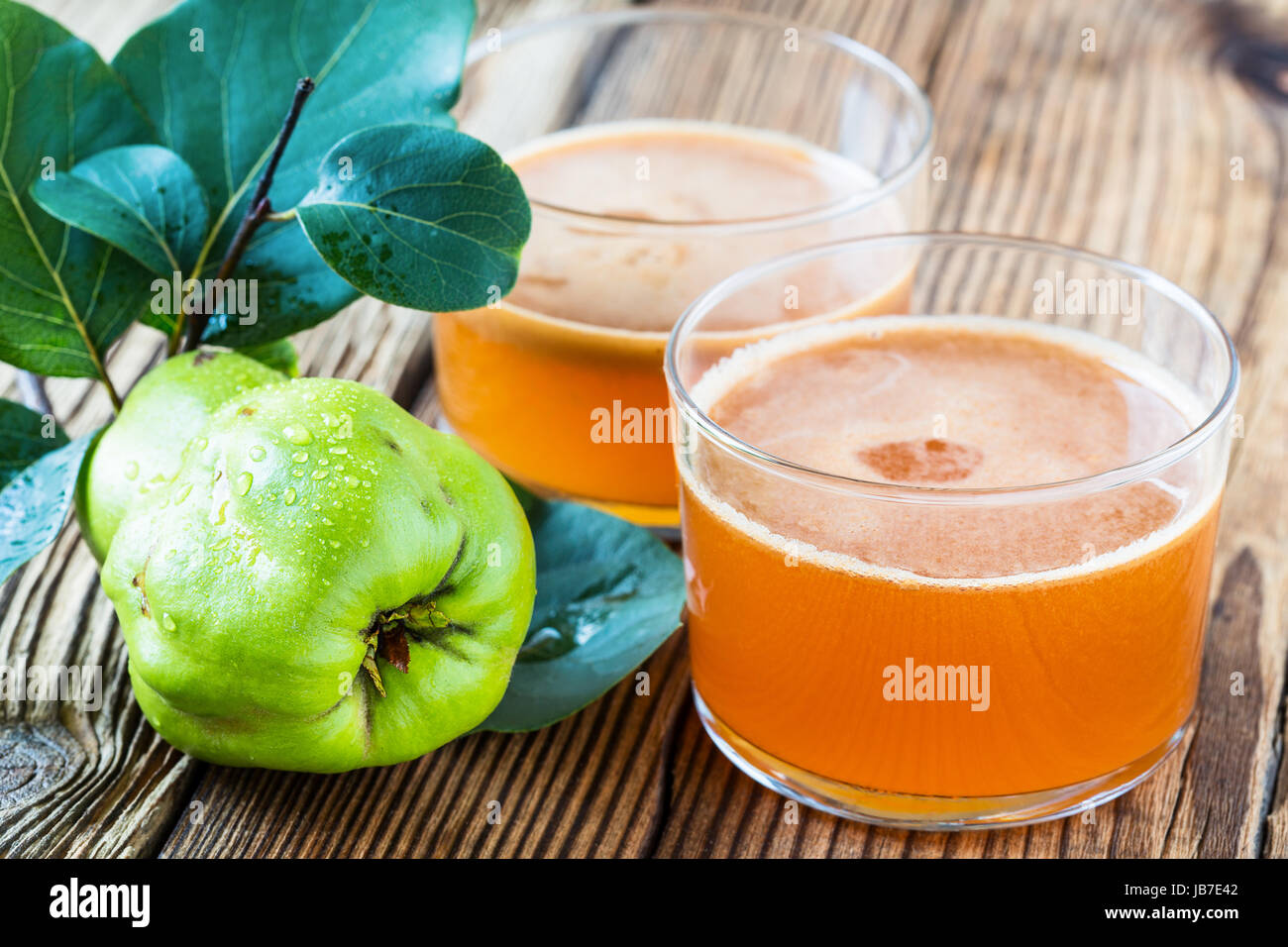 Homemade vegan fruit juice with sweet quince on rustic wooden table ...