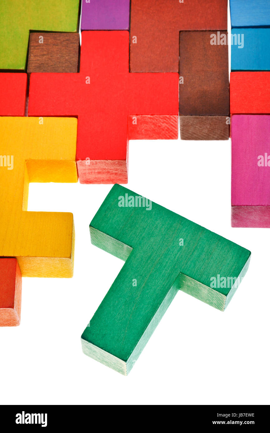T-shaped piece in wooden multicoloured puzzle isolated on white ...