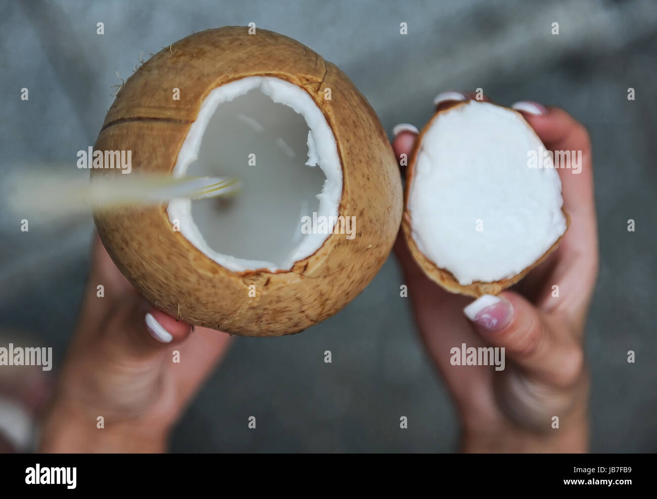Coconut in hand Stock Photo - Alamy