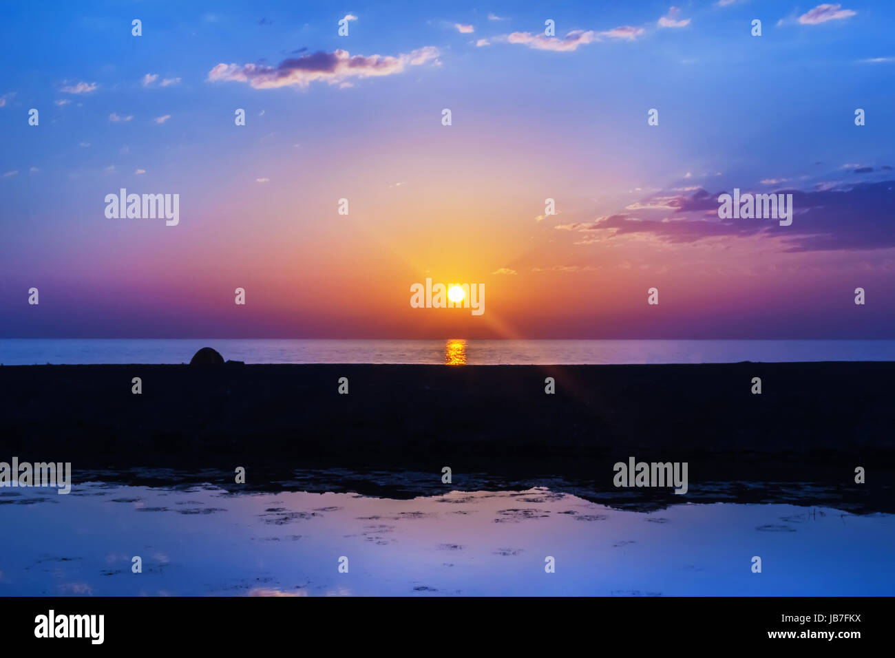Beauty setting sun over sea multicolour horizon Stock Photo - Alamy