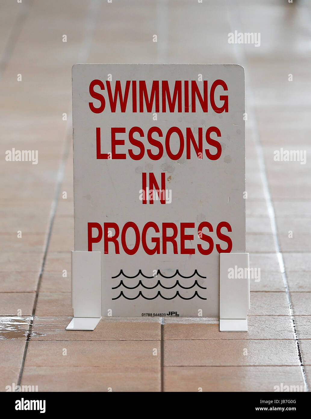 Swimming Lesson In Progress sign by the side of a swimming Pool Stock ...