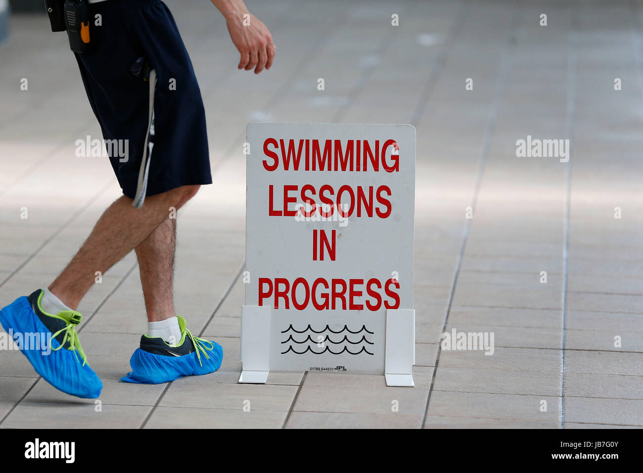 Swimming Lesson In Progress sign by the side of a swimming Pool Stock ...