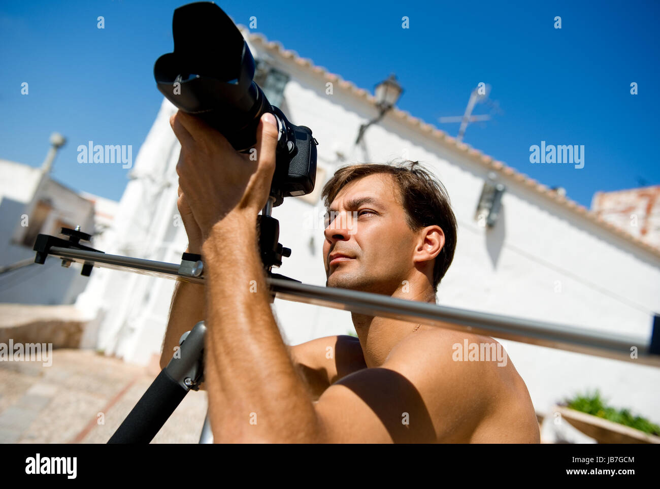 Handsome man with camcorder outdoors Stock Photo - Alamy