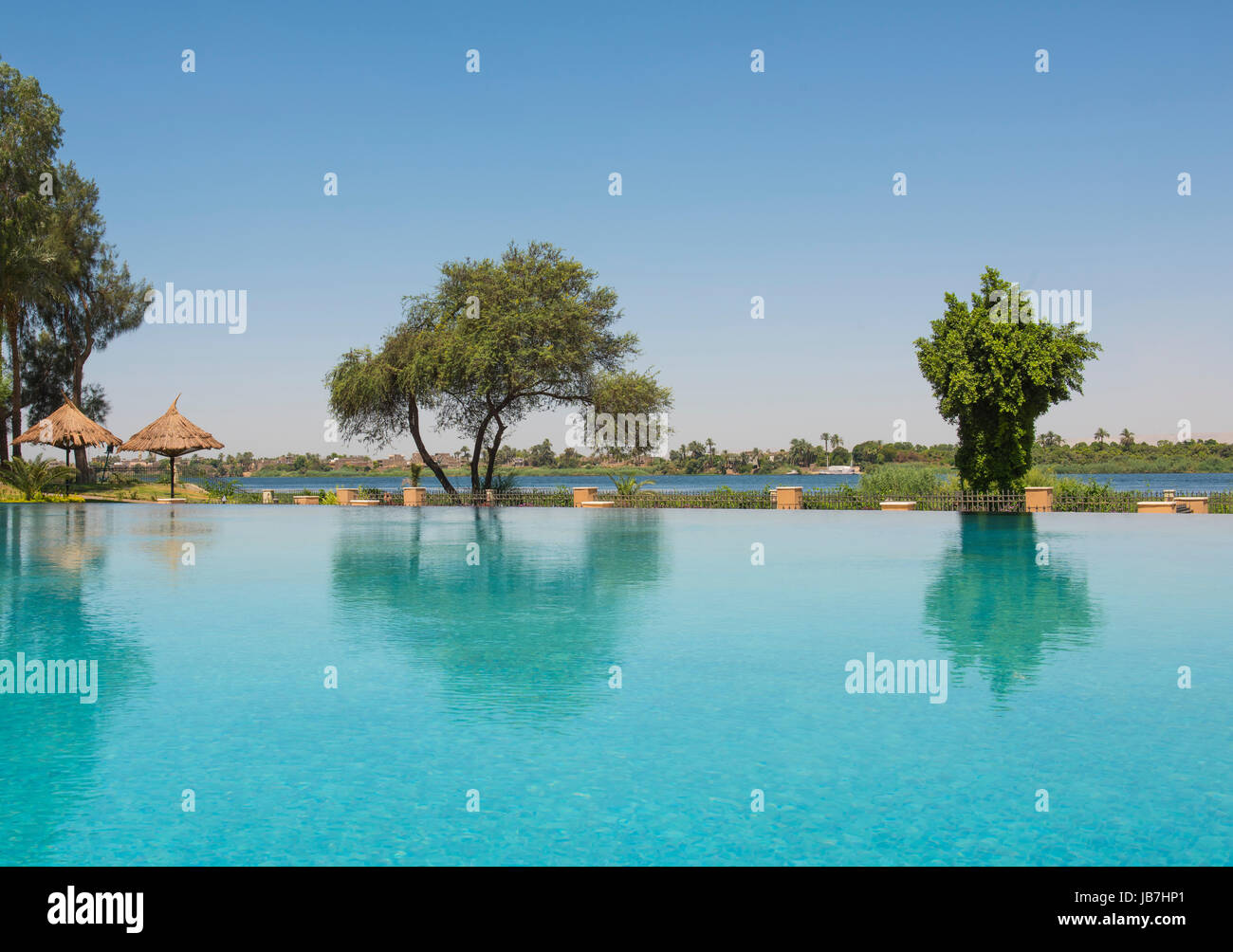 Outdoor infinity swimming pool at a tropical luxury hotel resort with ...