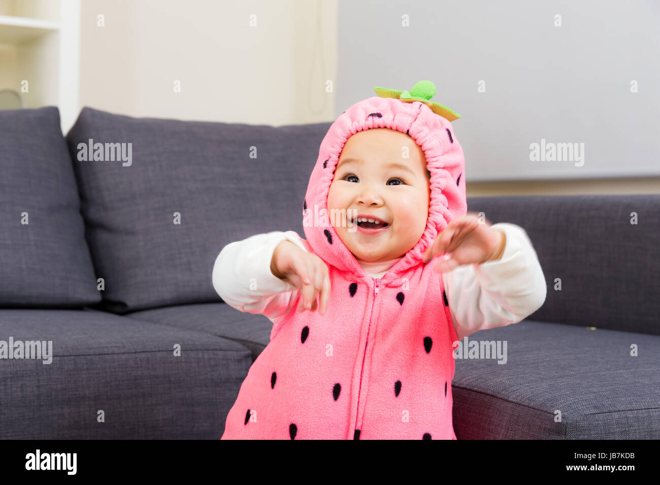 Baby with strawberry costume at home Stock Photo - Alamy