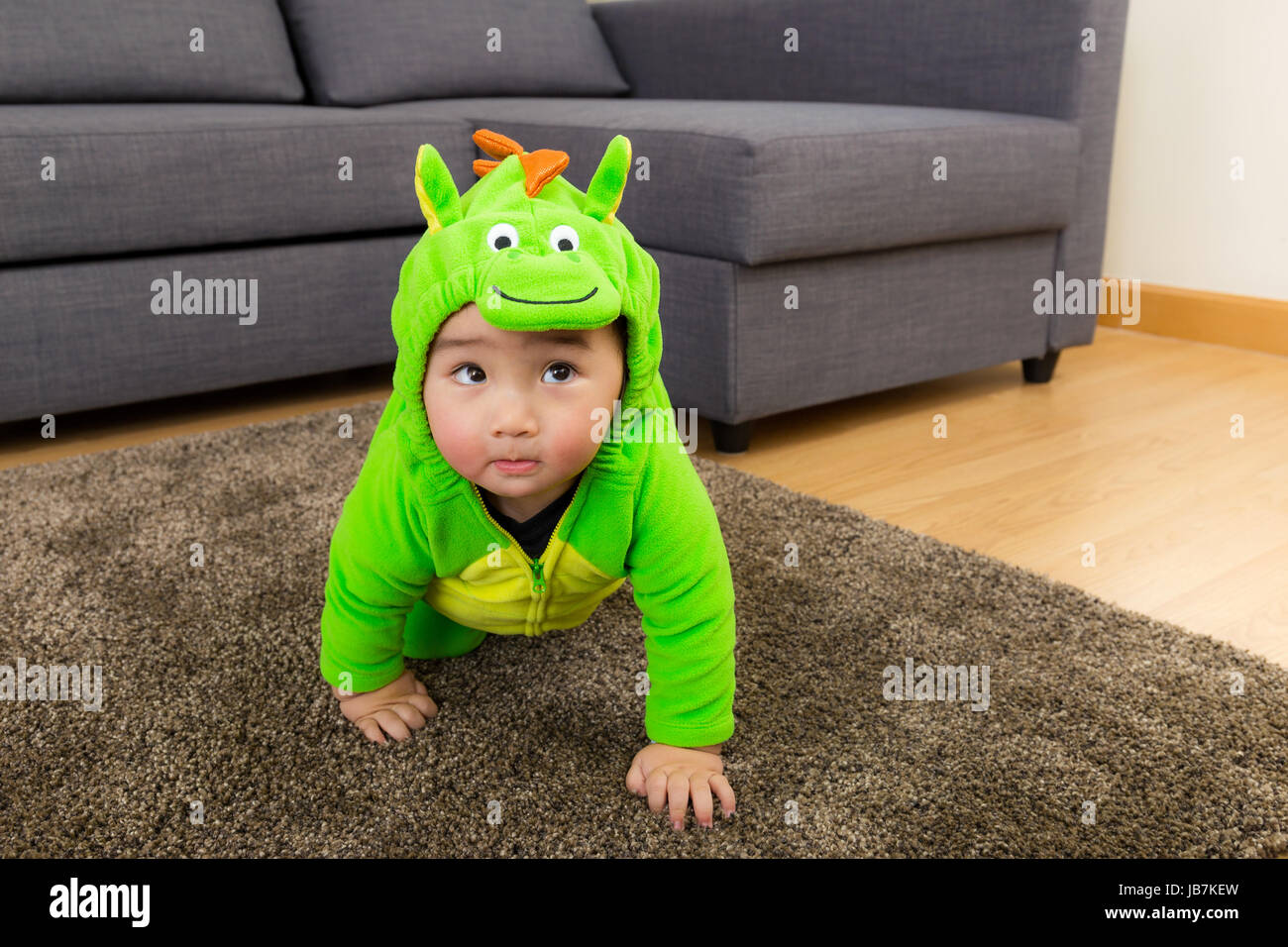 Young baby boy dressed in dinosaur Stock Photo - Alamy