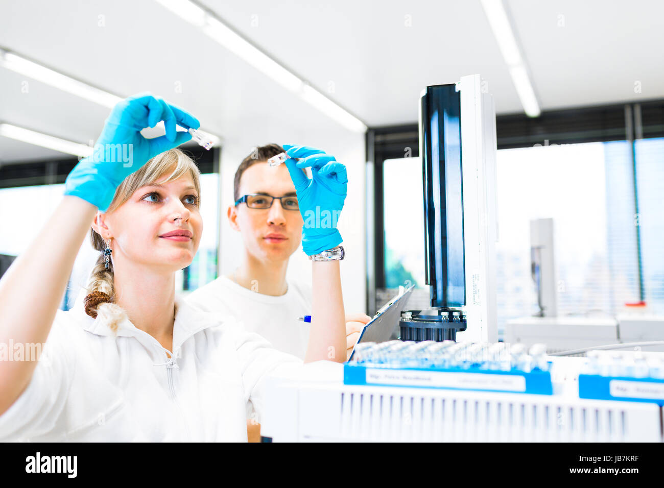 Two young researchers carrying out experiments in a lab (shallow DOF ...