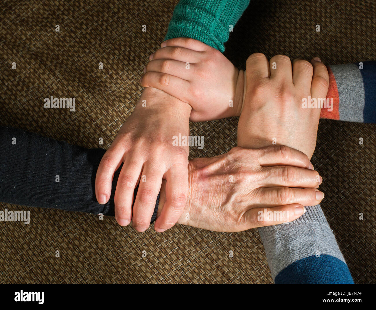 Many hands together. Interior shot Stock Photo - Alamy