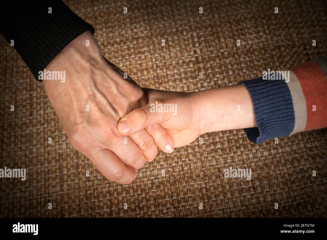 Two hands caught. Adult and child hand Stock Photo - Alamy