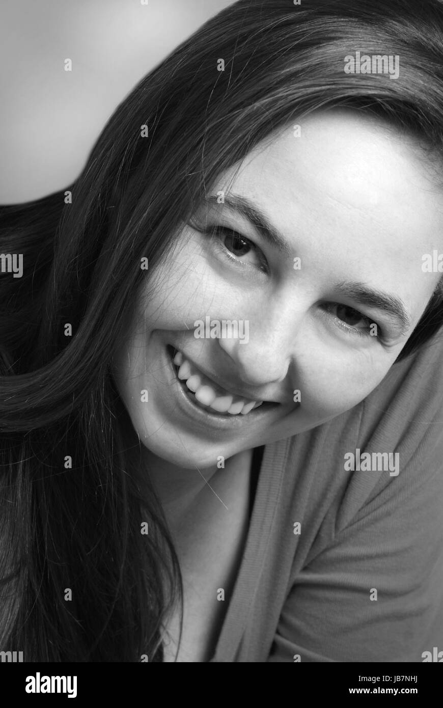 A woman smiles happily with a confident pose Stock Photo - Alamy