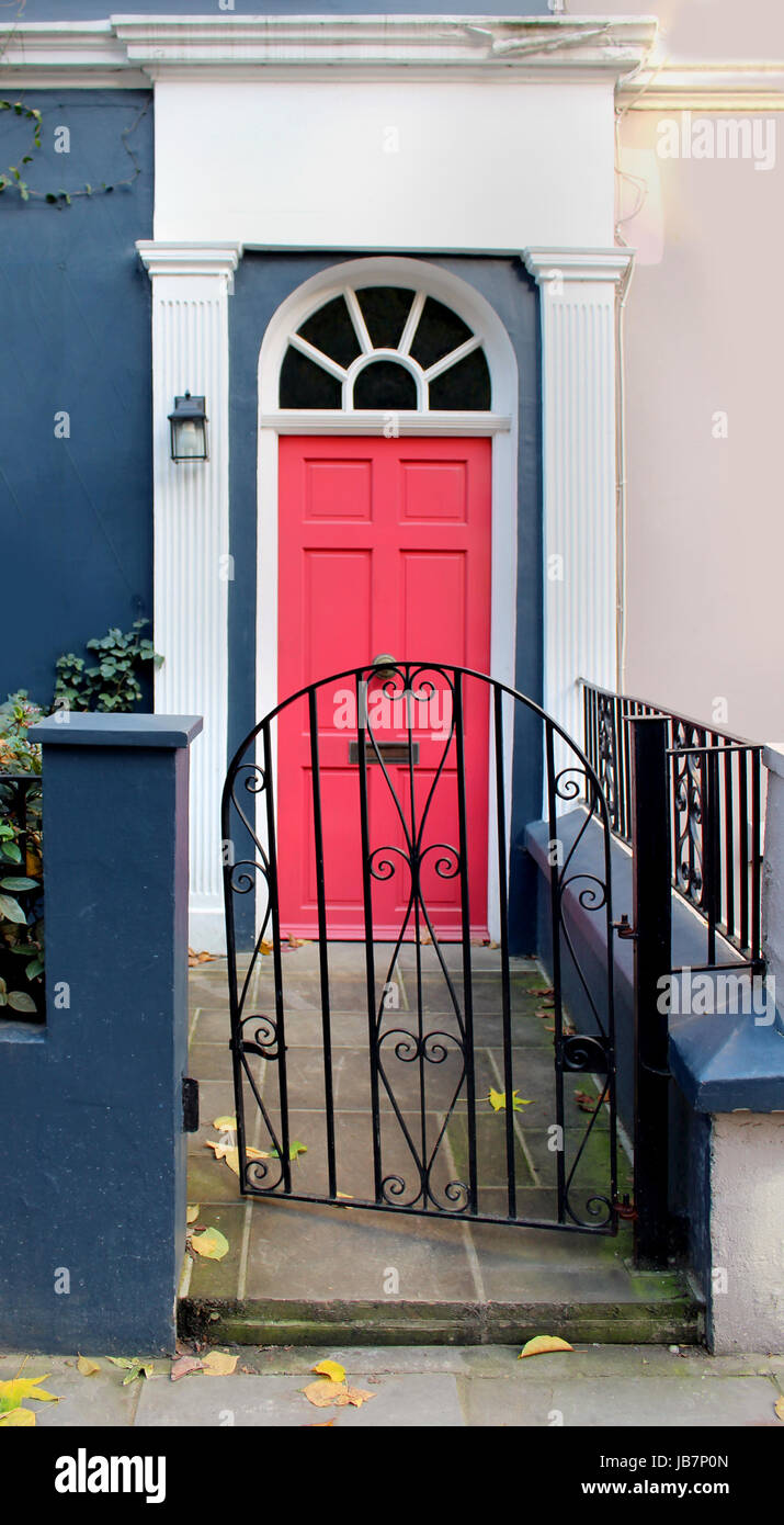 Residential entrance pathway with metal gate and pink door Stock Photo ...