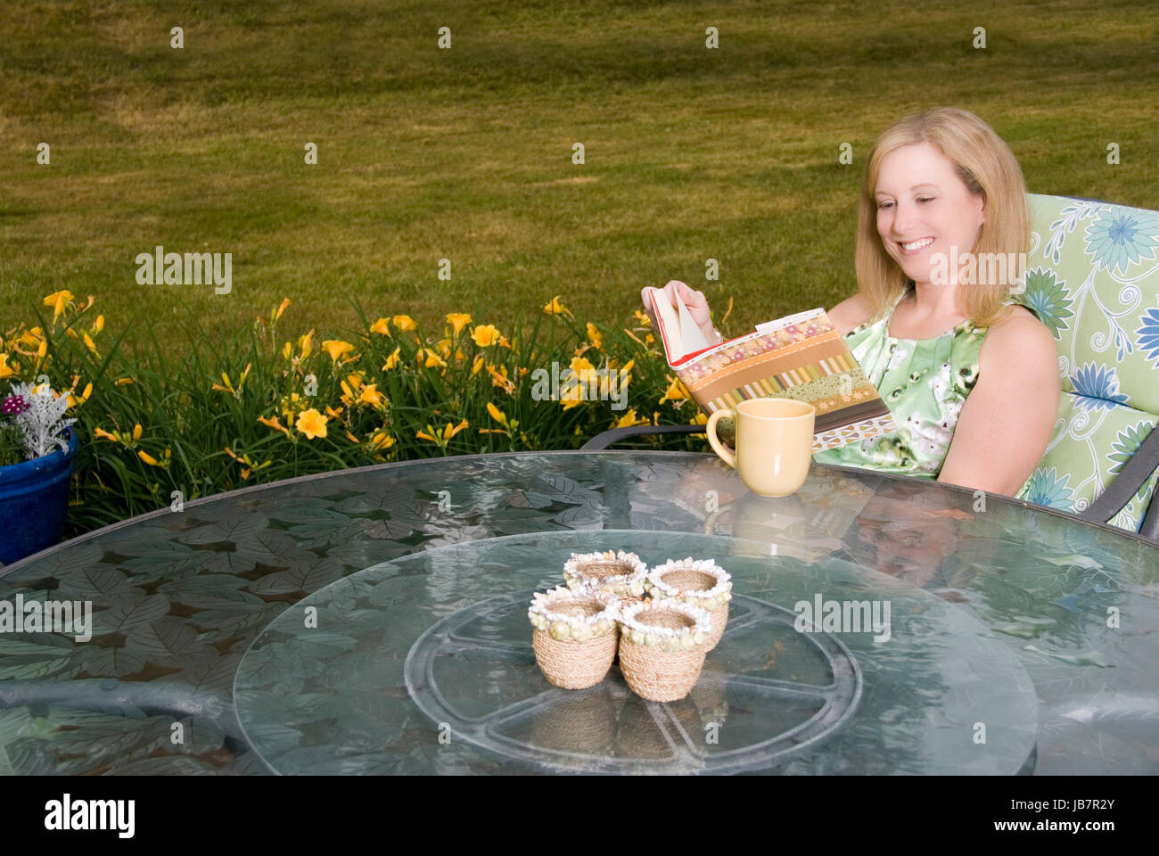 Woman alone sitting patio furniture hi-res stock photography and images ...