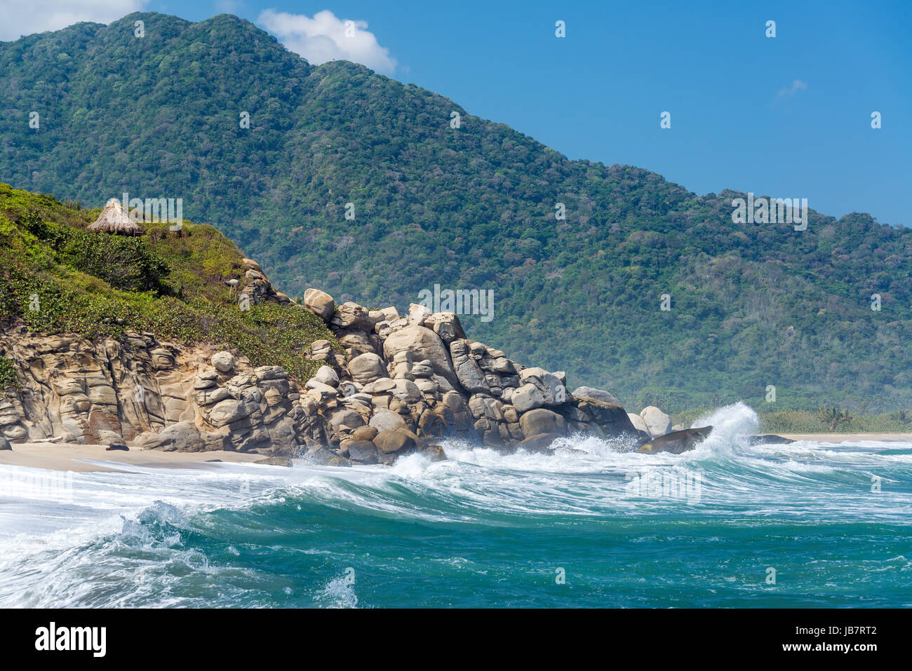 Beach in Tayrona National Park with beautiful green hills in the ...