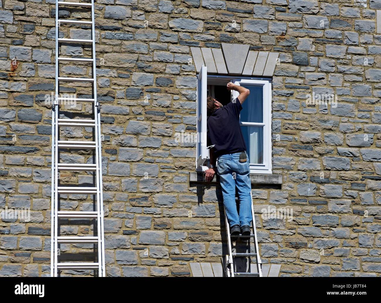 Man standing on ladder hi-res stock photography and images - Alamy