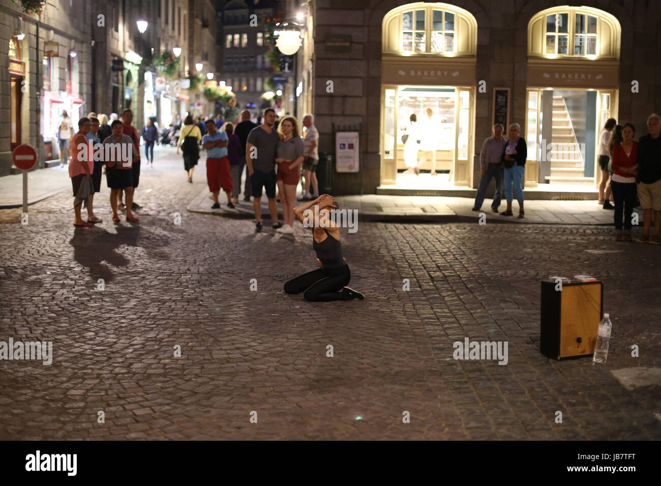 Female street performer in St Malo, France on cobbled street finishing ...