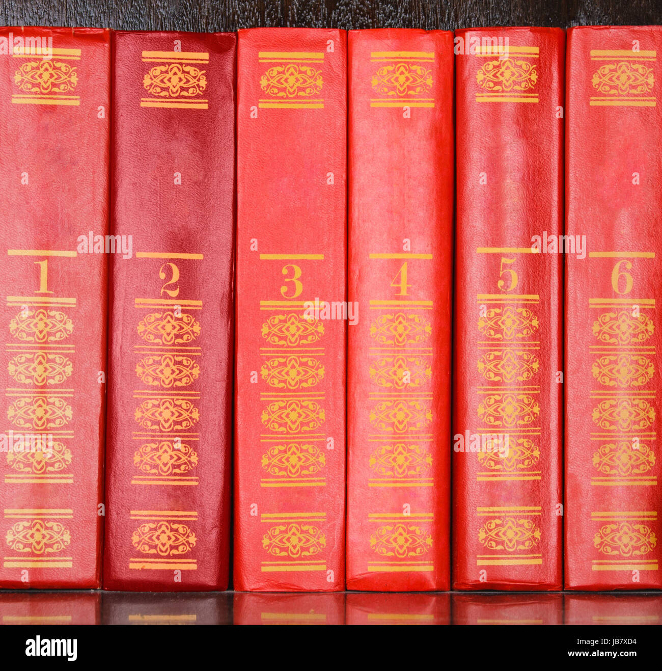 Red books standing in a row Stock Photo - Alamy
