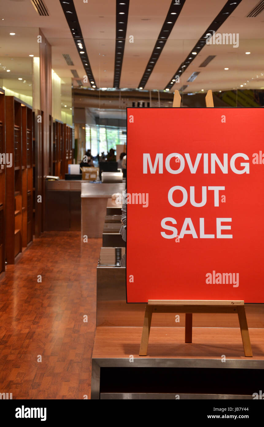Moving out sale label in front of store Stock Photo - Alamy