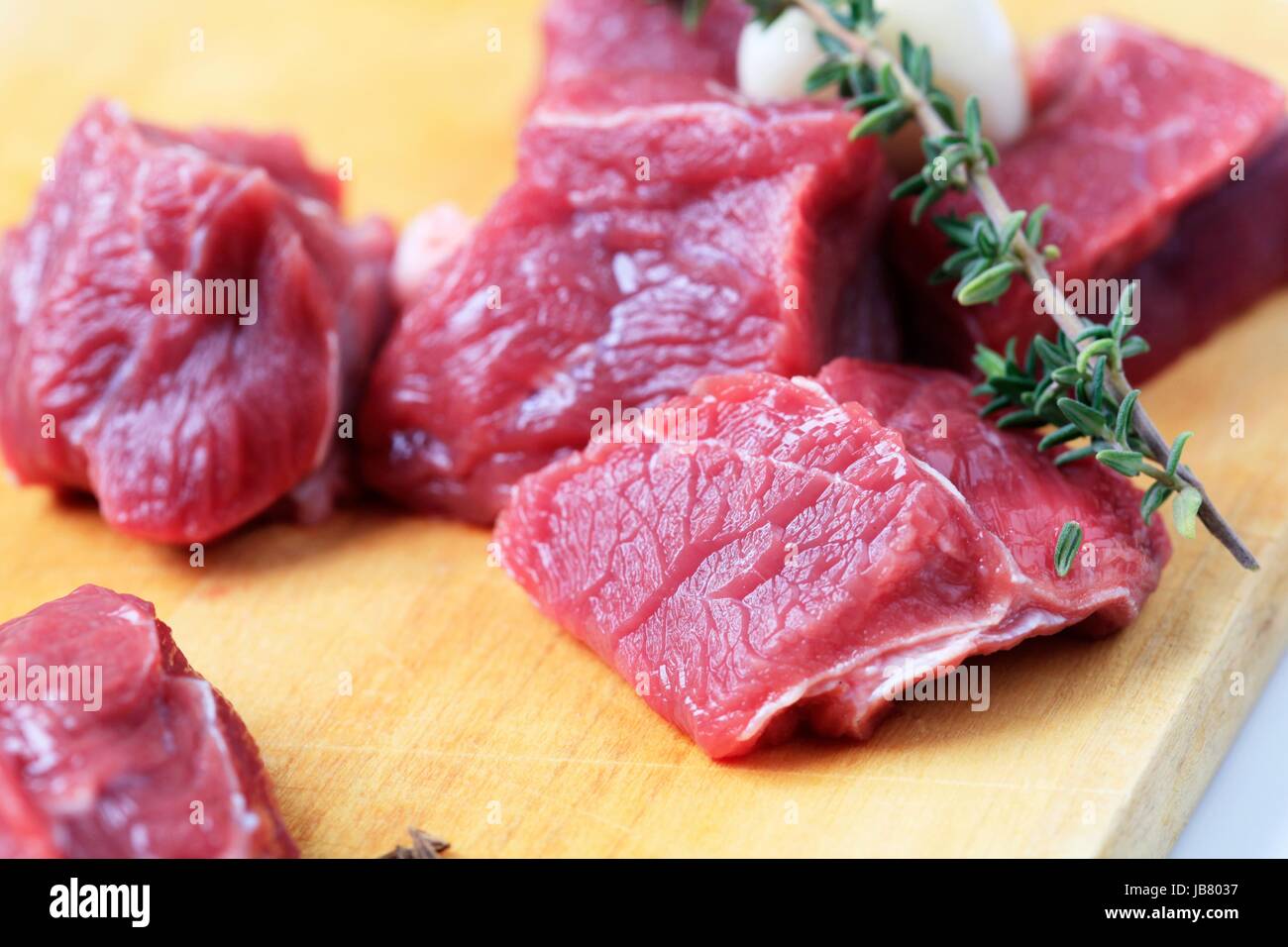 Chunks of raw beef meat on a cutting board Stock Photo - Alamy