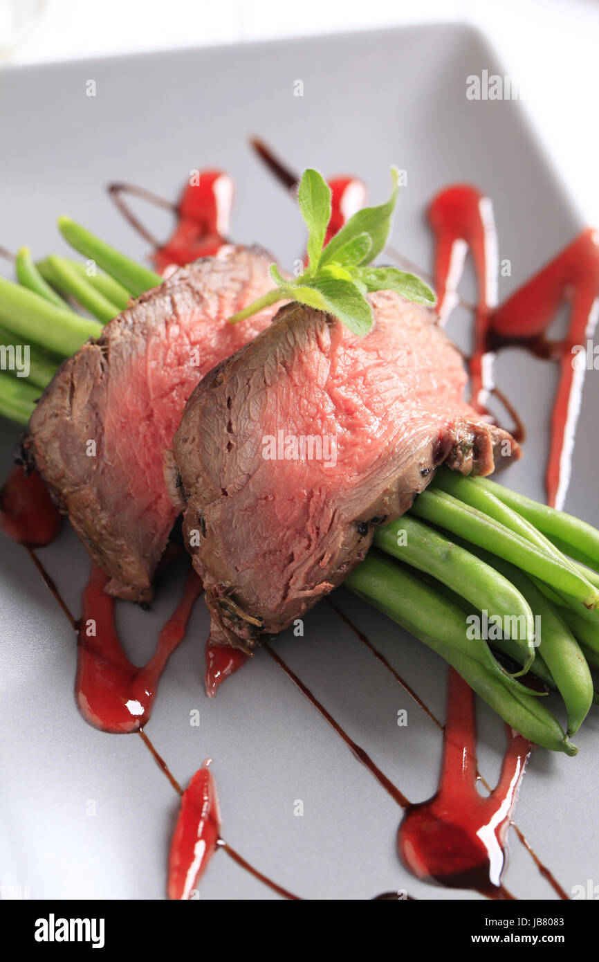 Slices of roast beef with string beans Stock Photo - Alamy