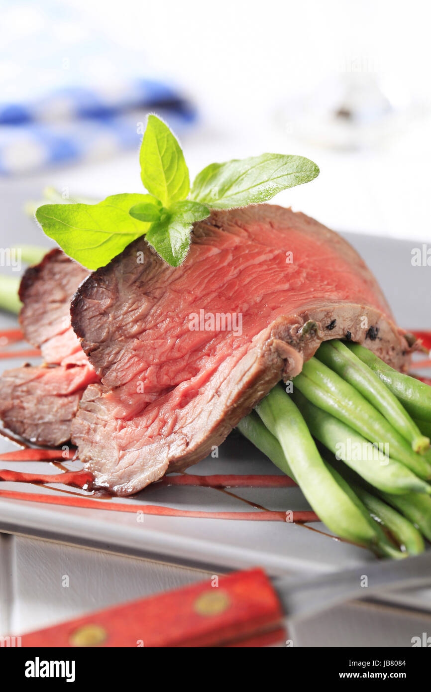 Slices of roast beef with string beans Stock Photo - Alamy
