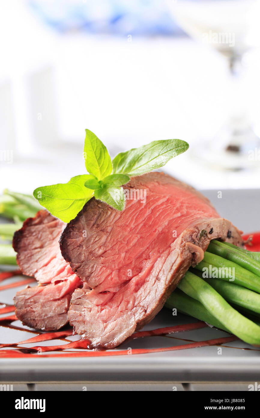 Slices of roast beef with string beans Stock Photo - Alamy