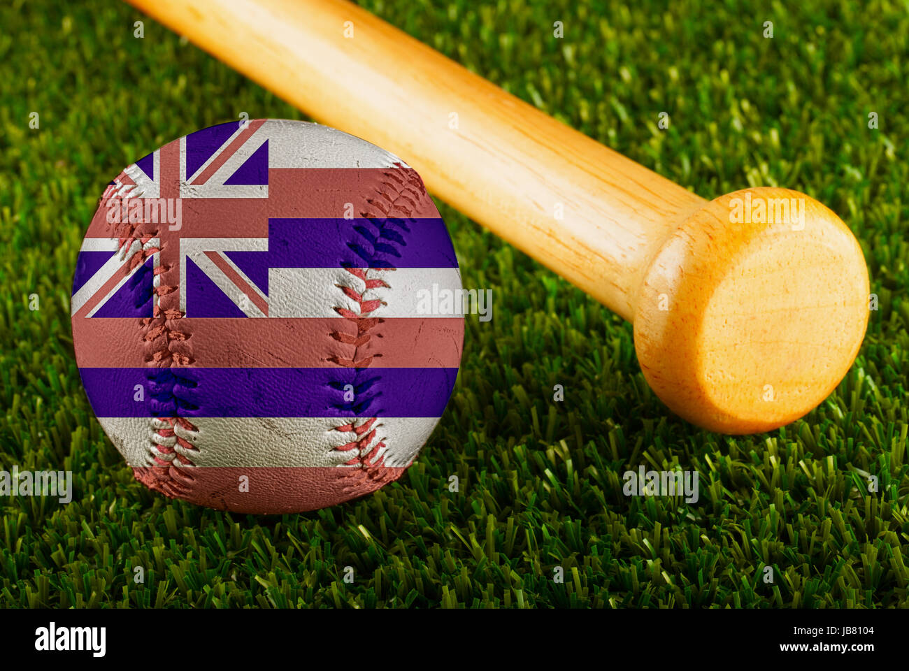 Baseball with Hawaii flag and bat over a background of green grass ...