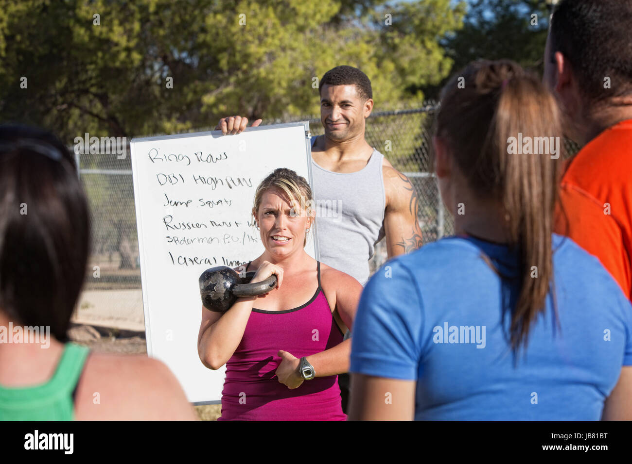 Boot camp fitness instructors explaining exercises to a class Stock ...