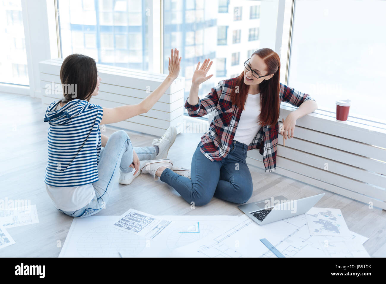 Happy delighted colleagues giving each other high five Stock Photo - Alamy