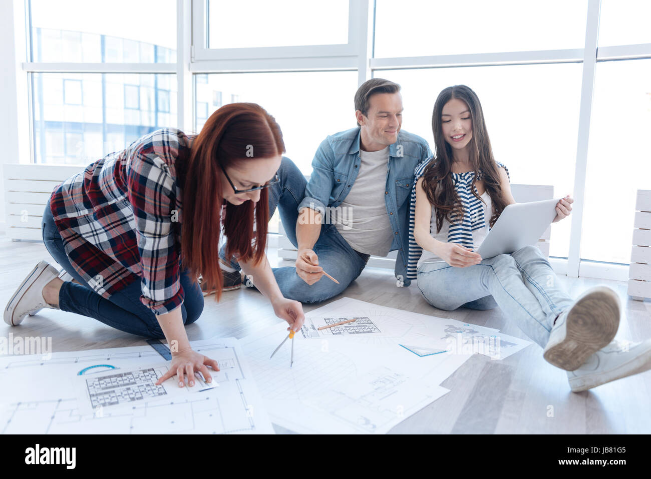 Hard working serious architect working on a drawing Stock Photo - Alamy