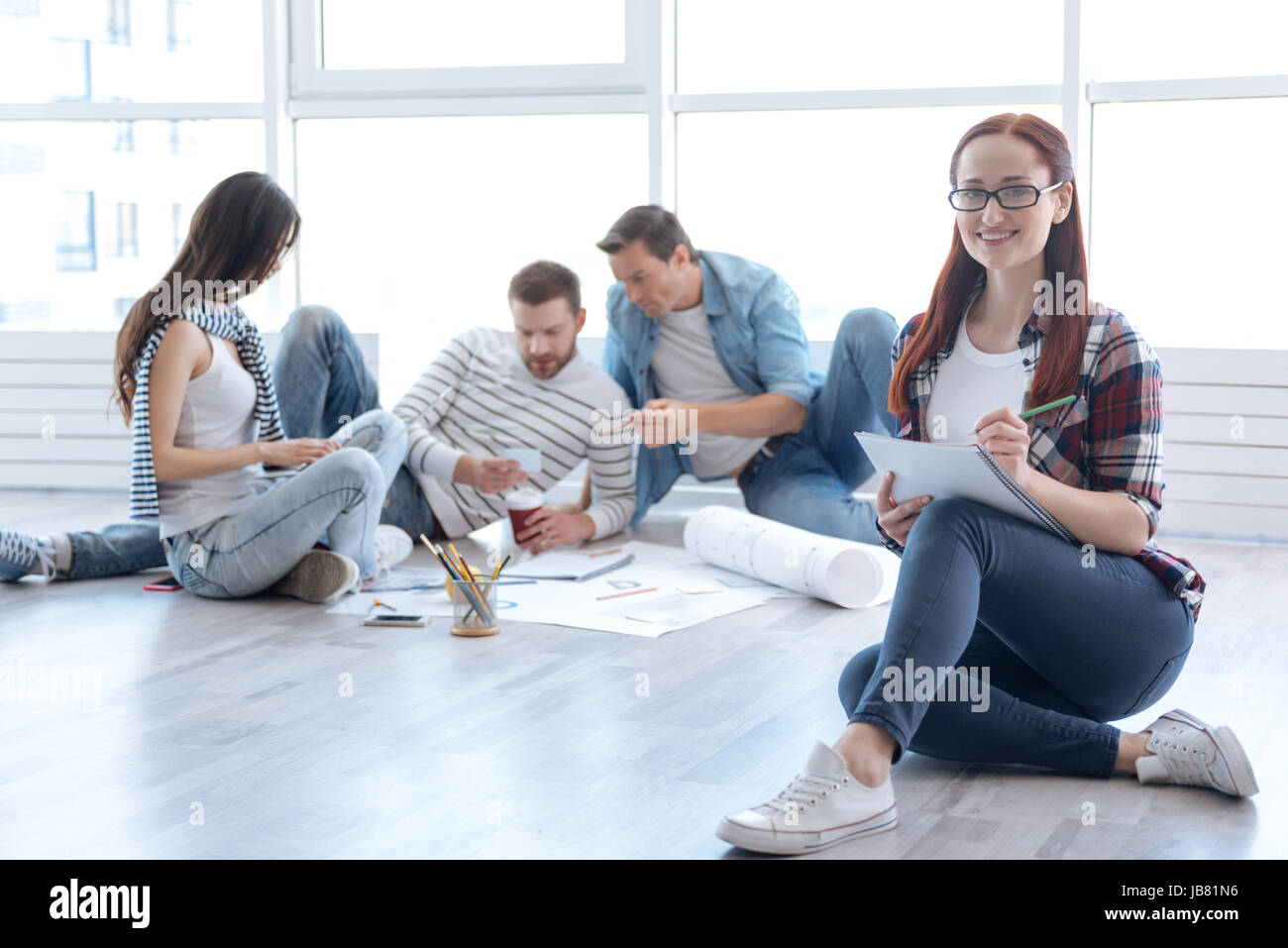 Happy intelligent woman taking notes Stock Photo - Alamy