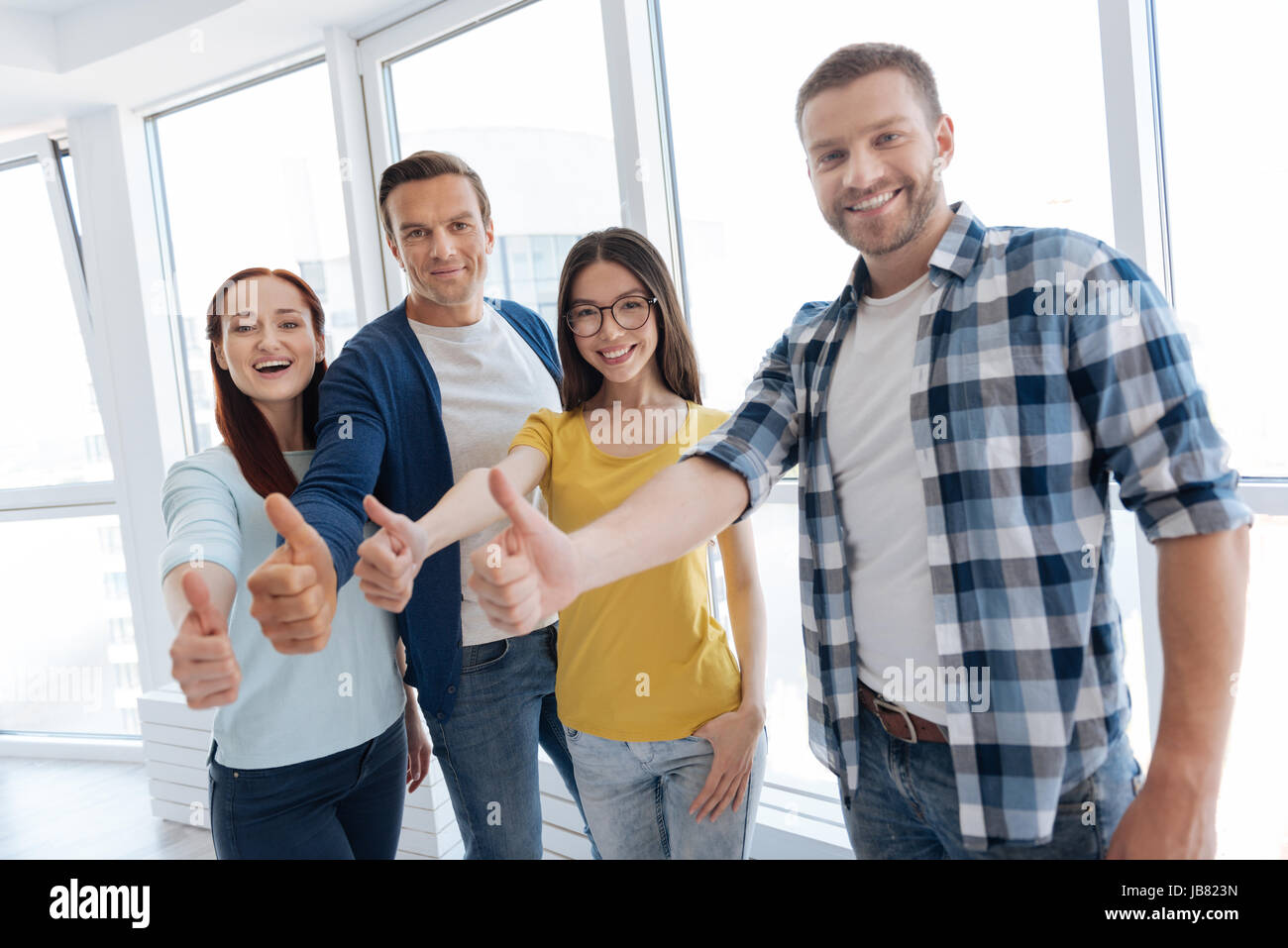 Joyful positive people showing OK signs Stock Photo - Alamy