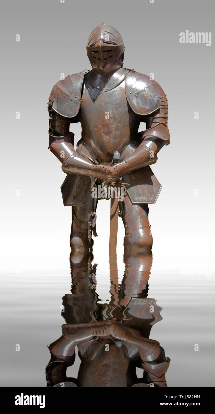 sunny illuminated historic rusty plate armour on mirroring water ...