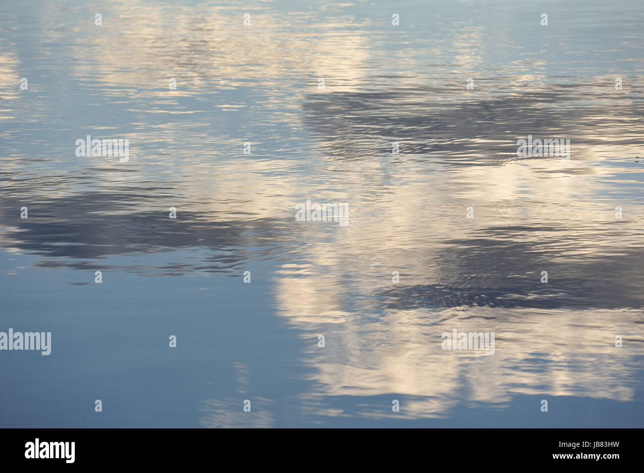 Watercolor. Reflection of clouds on the water surface Stock Photo - Alamy