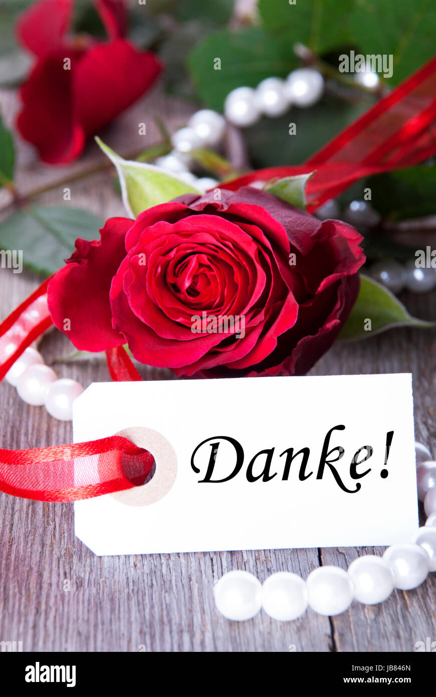 A Background with Rose and Pearls and the German Word Danke Which Means ...