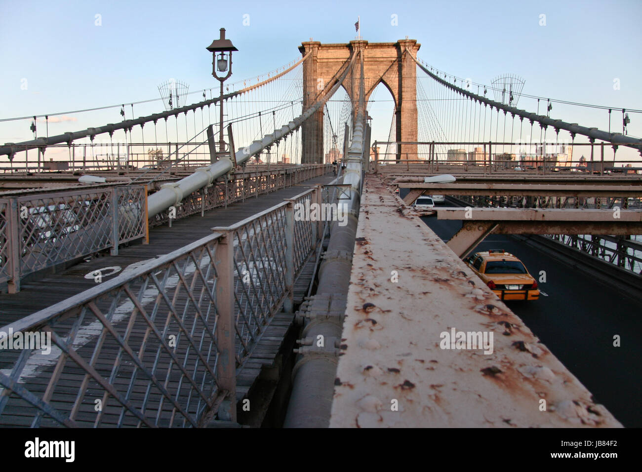 Rusty structure detail of brooklyn bridge with pedestrian walk and road ...