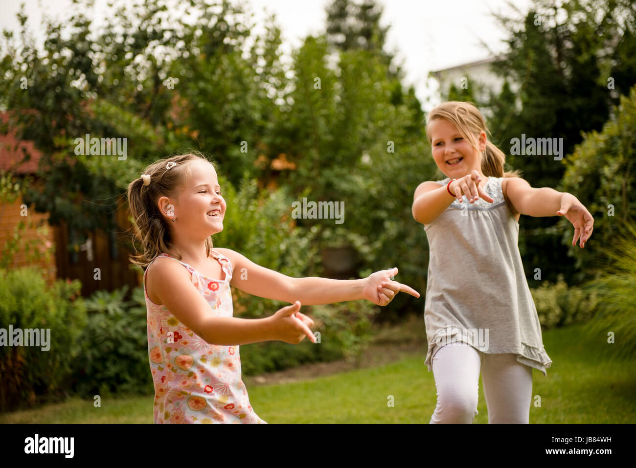 Active childhood - happy child dancing outdoor in backyard Stock Photo ...