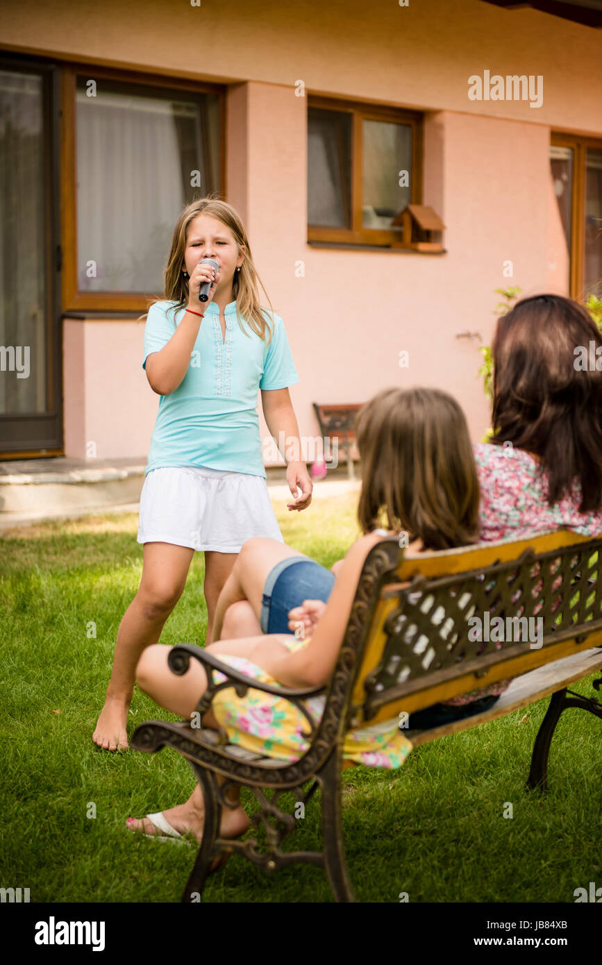 Child singing outside microphone hi-res stock photography and images ...