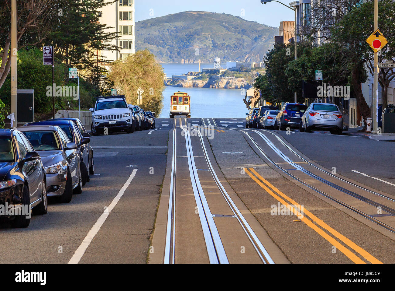 A cable car arriving at the top of a hill in San Francisco Stock Photo ...