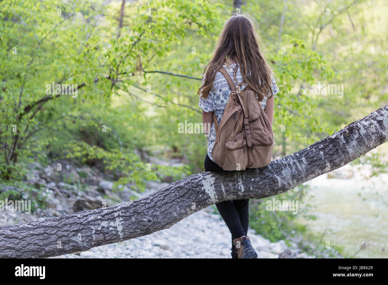 Girl sitting on branch of tree hi-res stock photography and images - Alamy