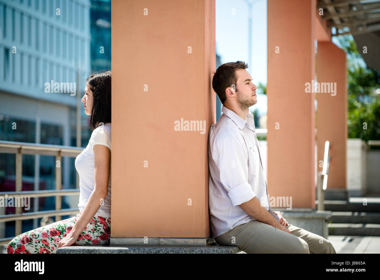 Couple having problems - two people sitting on opposite side of big ...