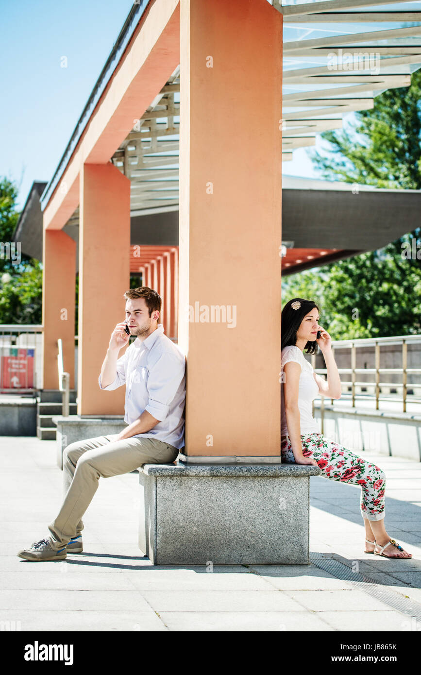 Couple having problems - two people sitting on opposite side of big ...