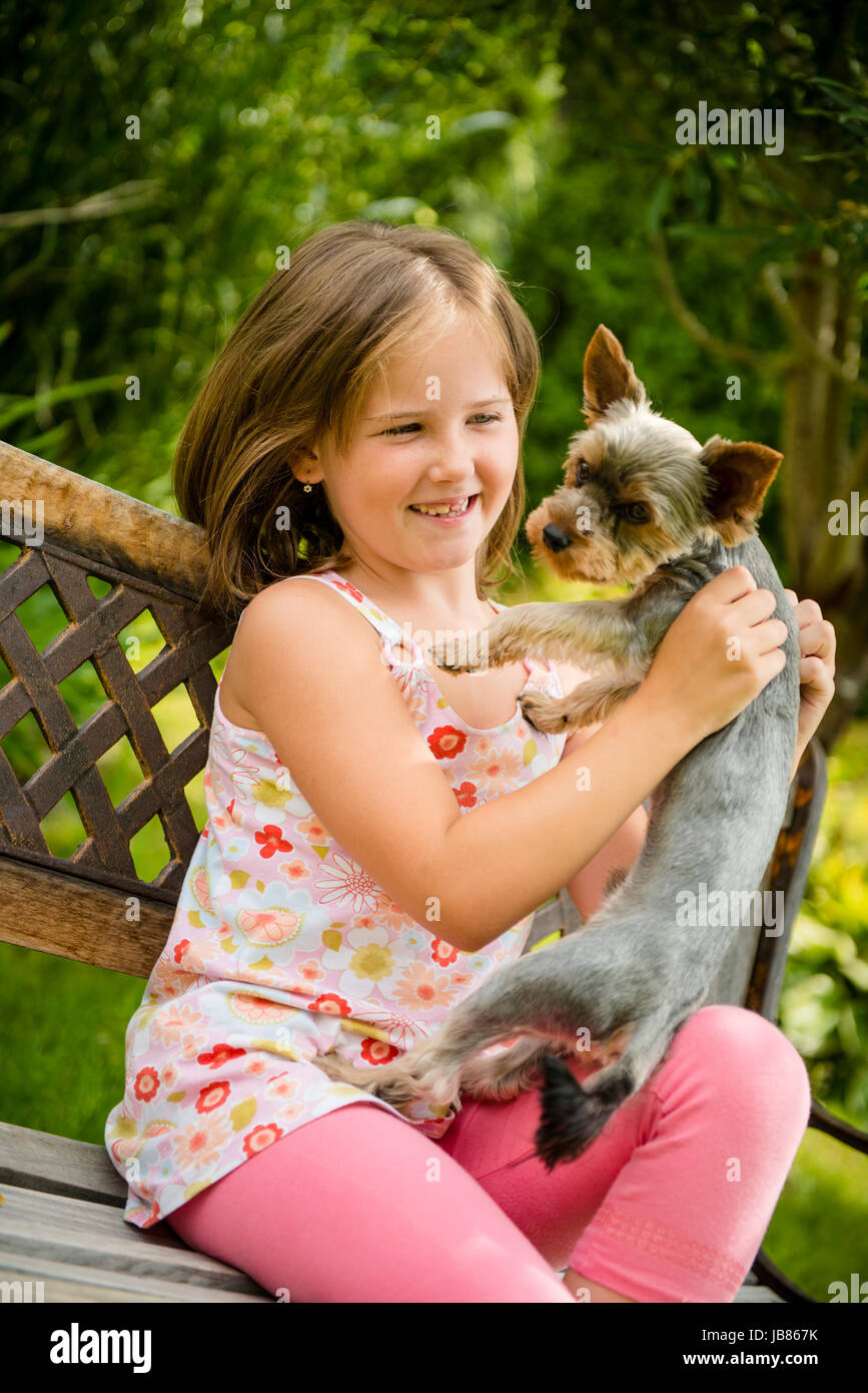 Happy smiling child playing with their pet - outdoor in backyard Stock ...