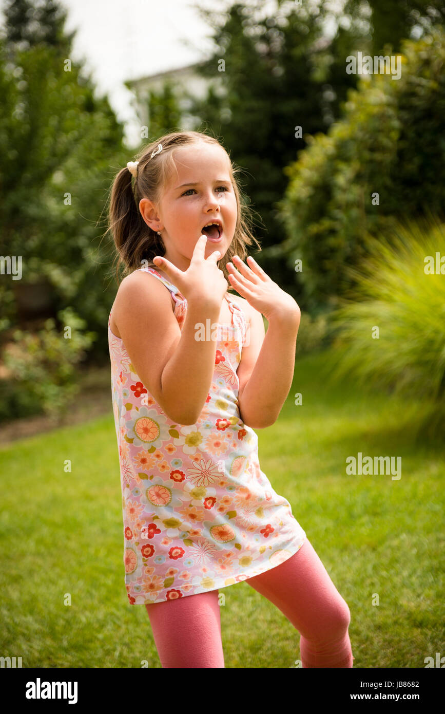 Active childhood - happy child dancing outdoor in backyard Stock Photo ...