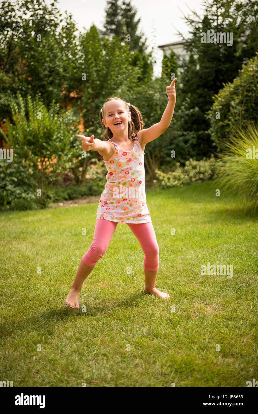 Active childhood - happy child dancing outdoor in backyard Stock Photo ...