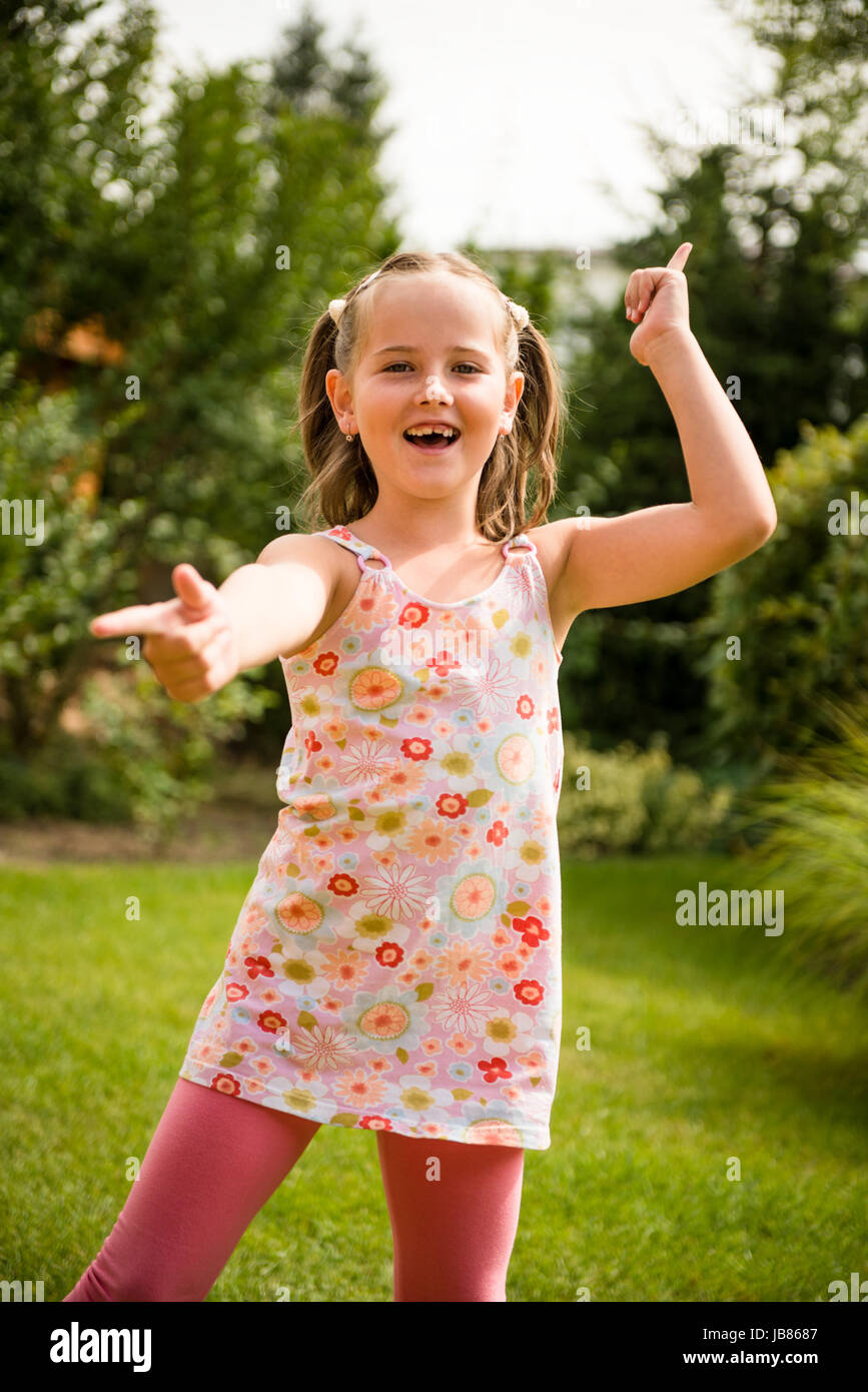 Active childhood - happy child dancing outdoor in backyard Stock Photo ...