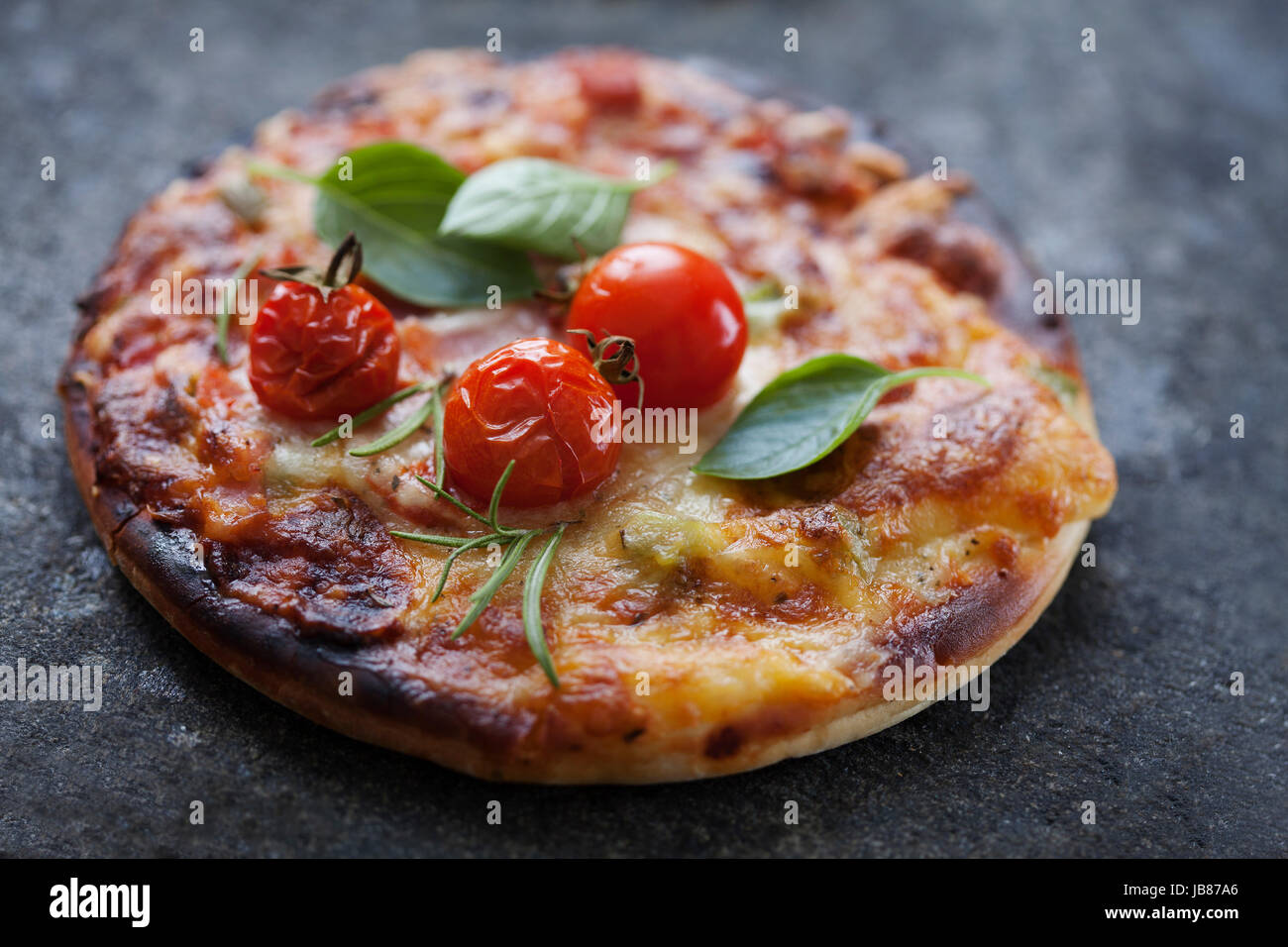 small pizzas with ham, bacon, cheese and tomatoess Stock Photo - Alamy
