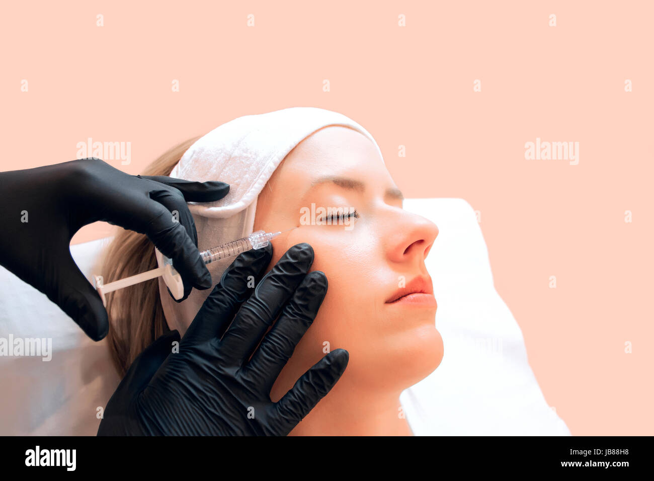 Woman giving botox injections. Young woman gets beauty facial ...