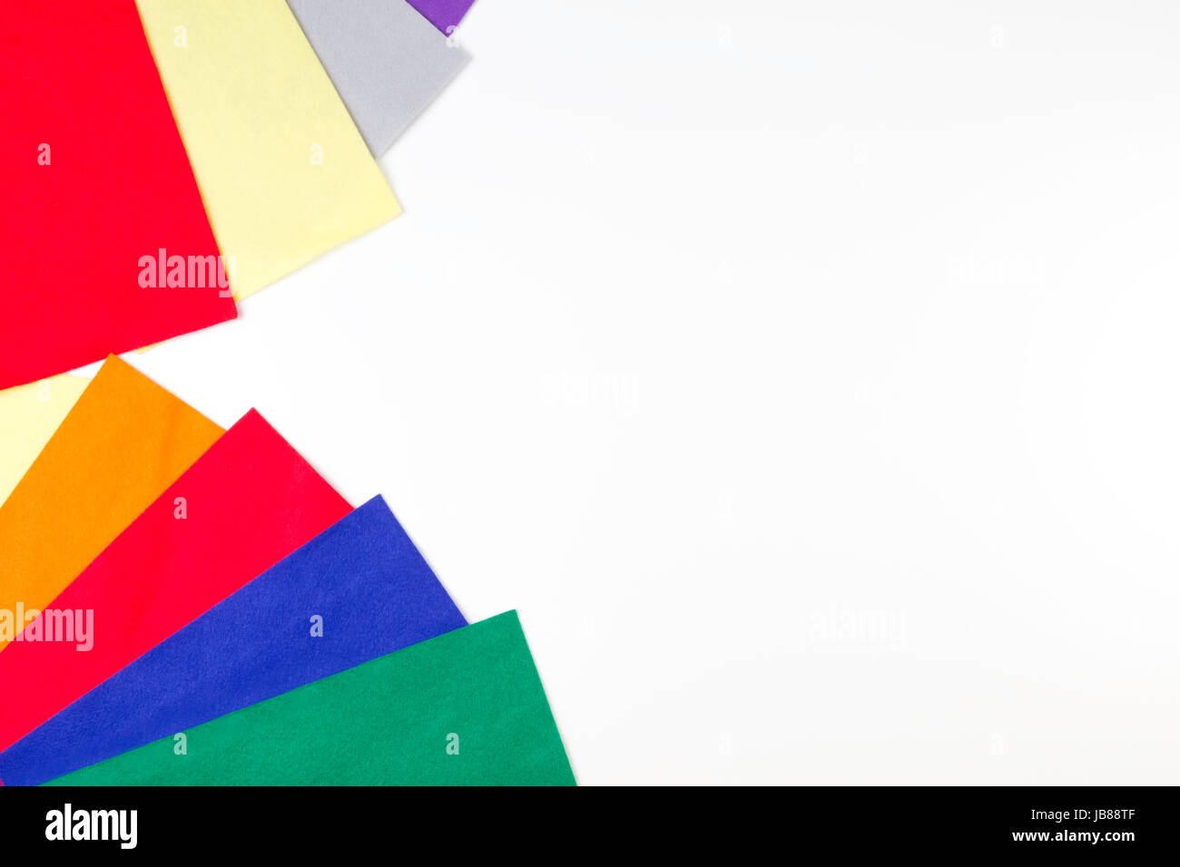 Selection of colorful felt sheets arranged as border frame on white ...