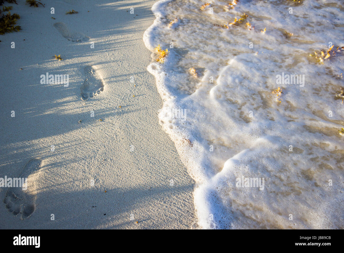 Photograph of some footprints on the beach Stock Photo - Alamy