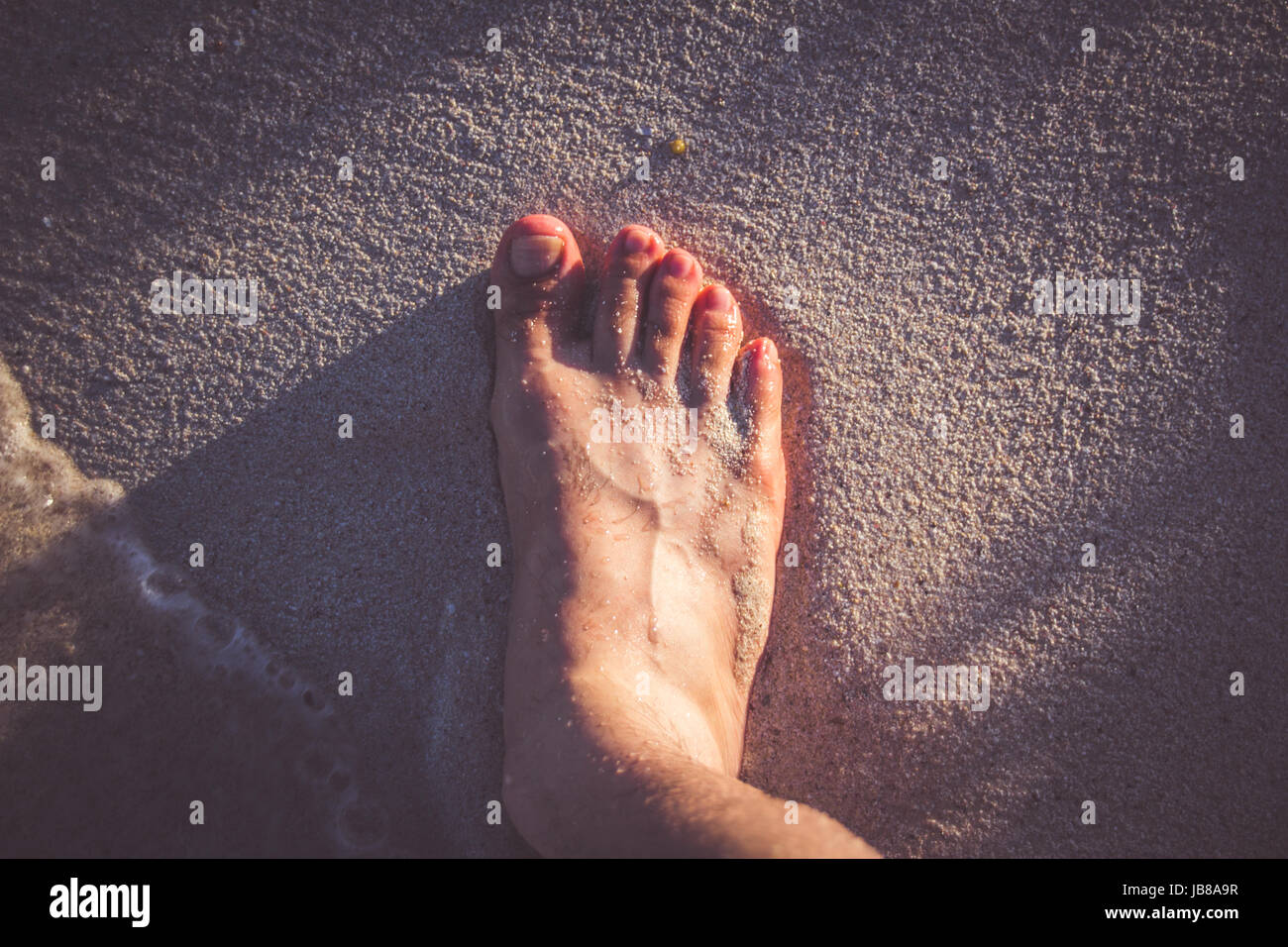 Photograph of a human foot on beach sand Stock Photo - Alamy